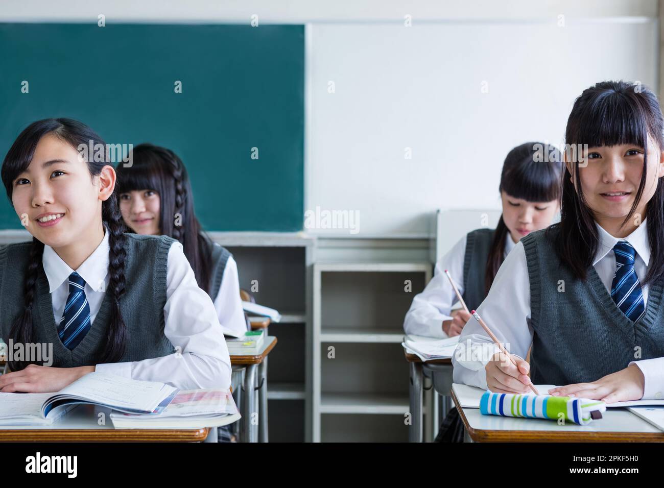 Junior high school girls taking a class Stock Photo - Alamy