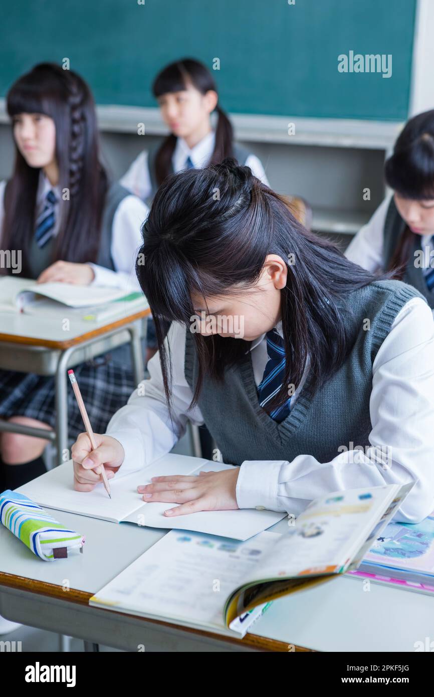 Junior high school girls taking a class Stock Photo - Alamy