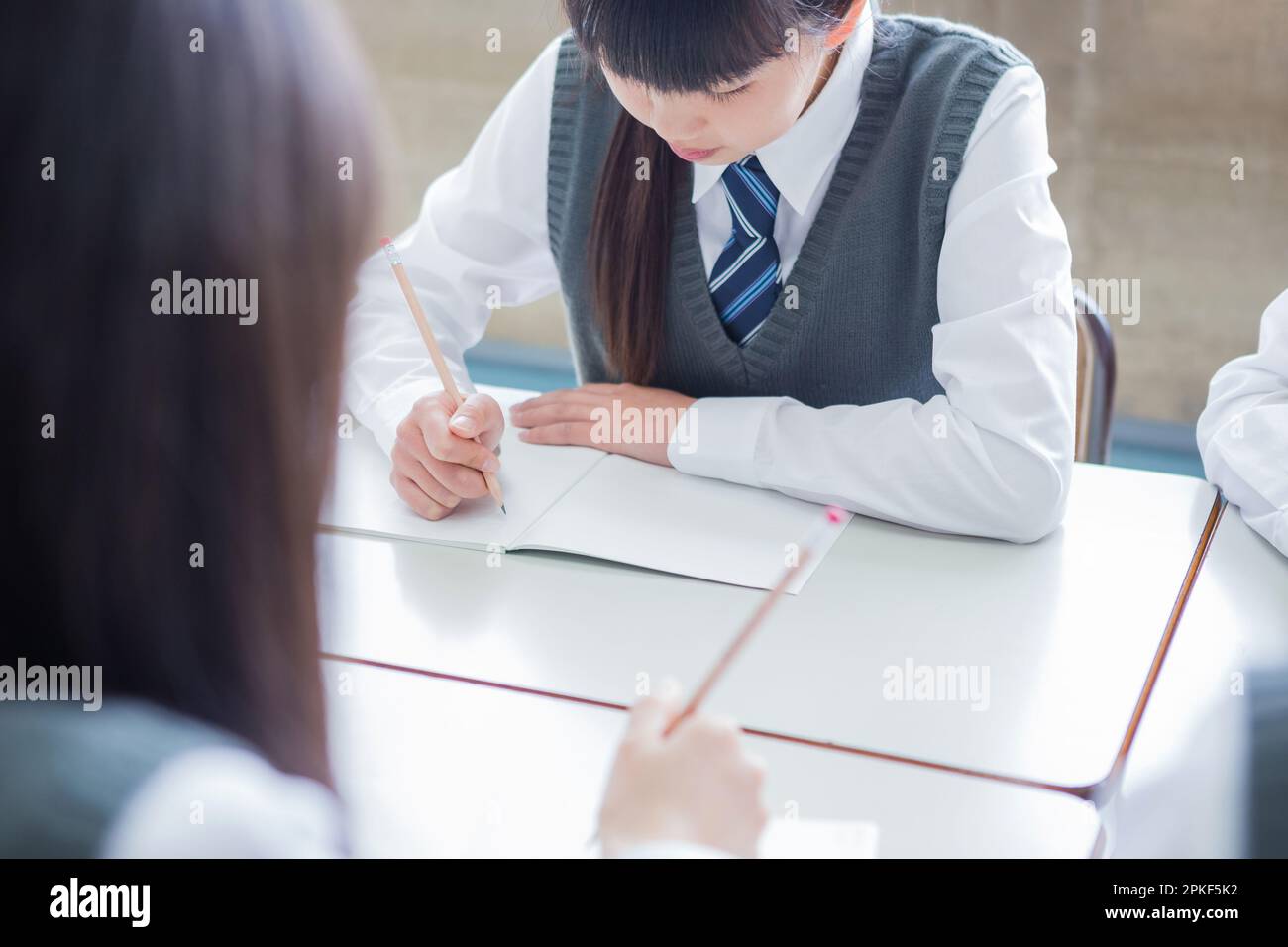 Junior high school girls doing group work Stock Photo - Alamy