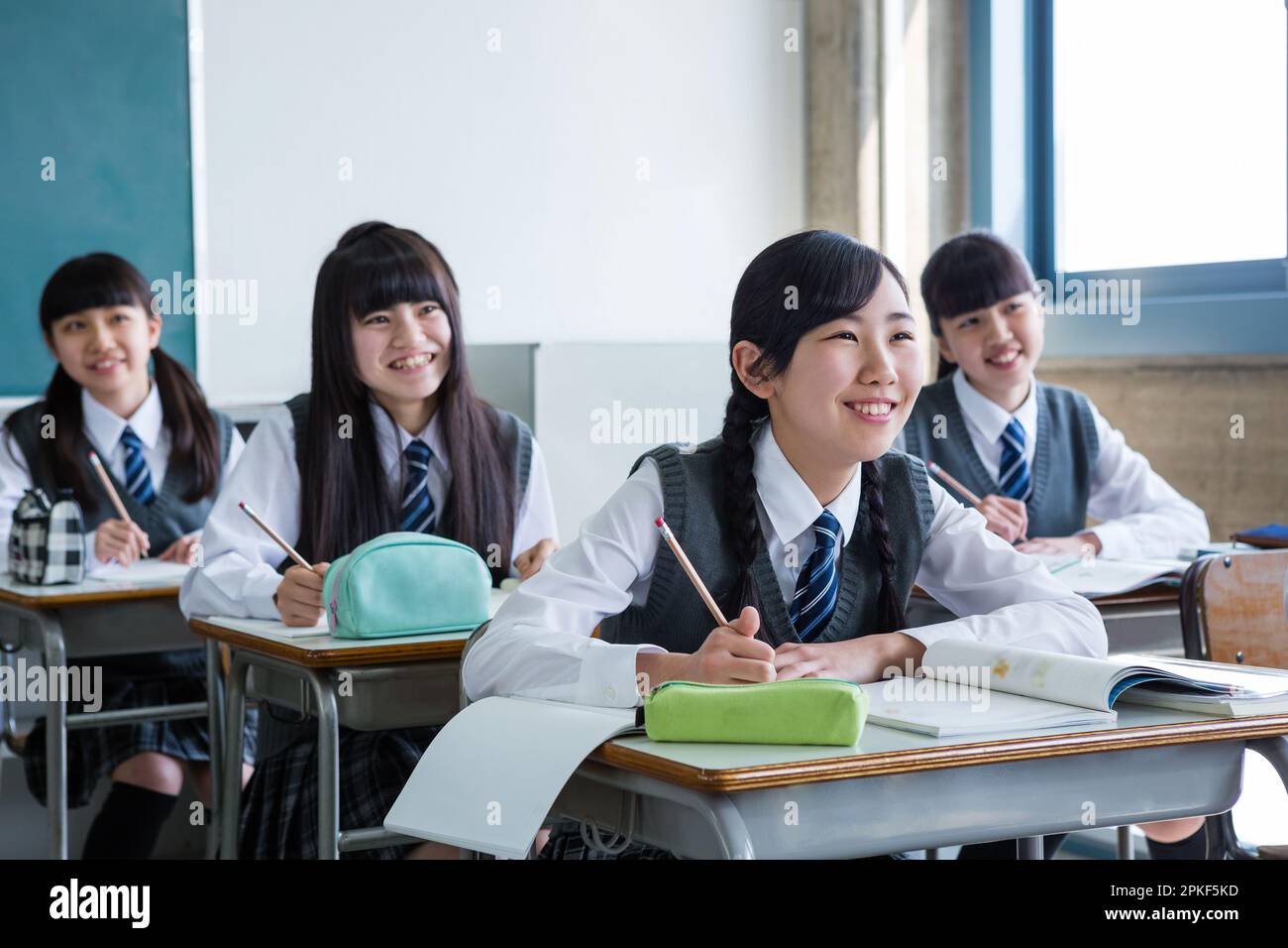 Junior high school girls taking a class Stock Photo - Alamy