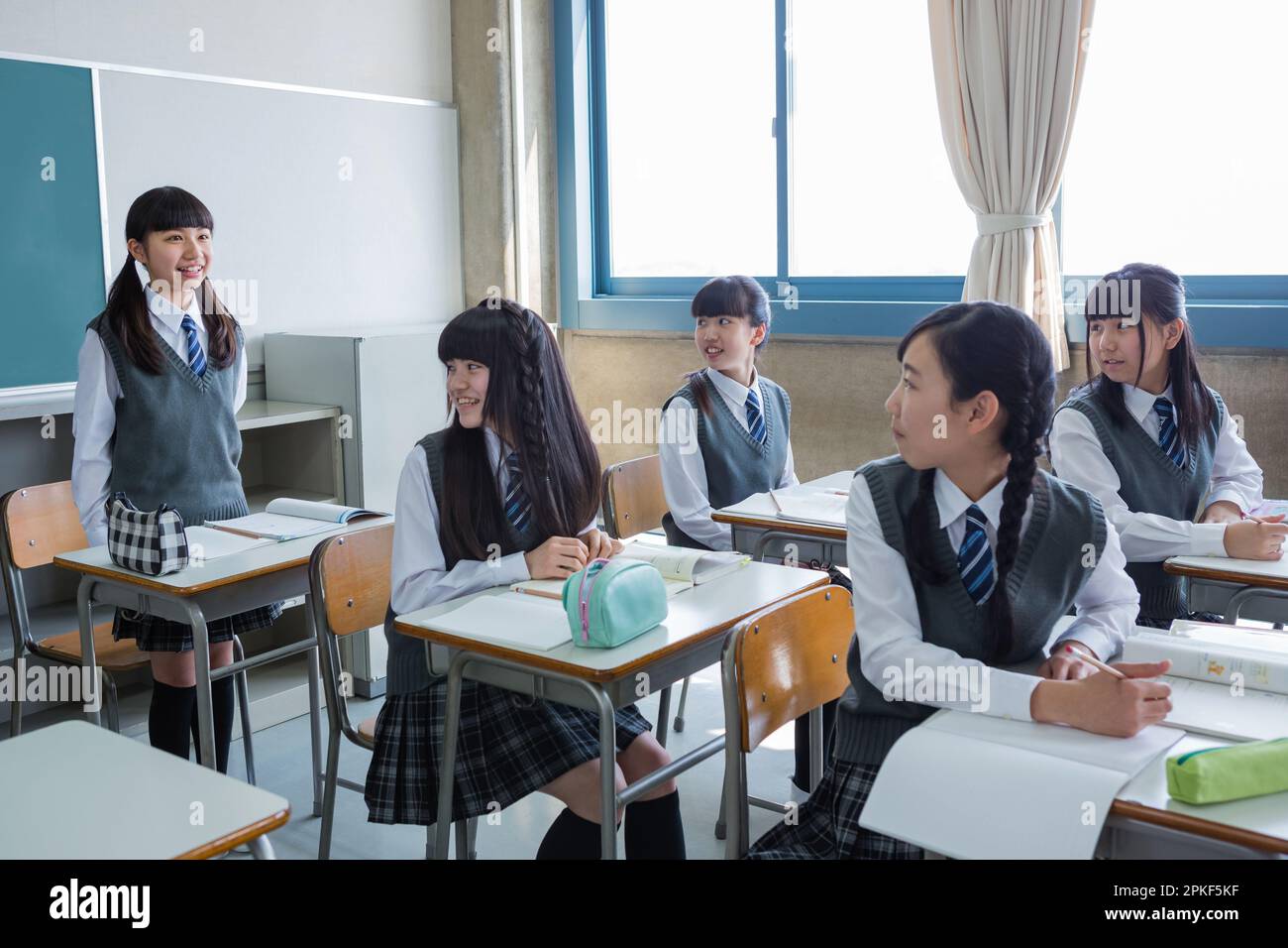 Junior high school girls taking a class Stock Photo - Alamy