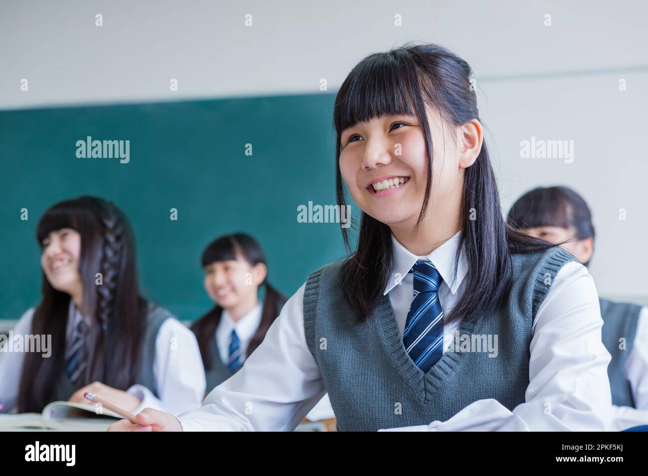 Junior high school girls taking a class Stock Photo - Alamy