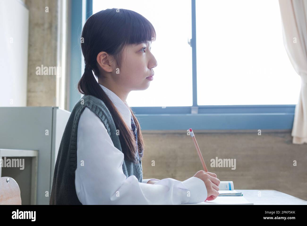 Junior high school girls taking a class Stock Photo - Alamy