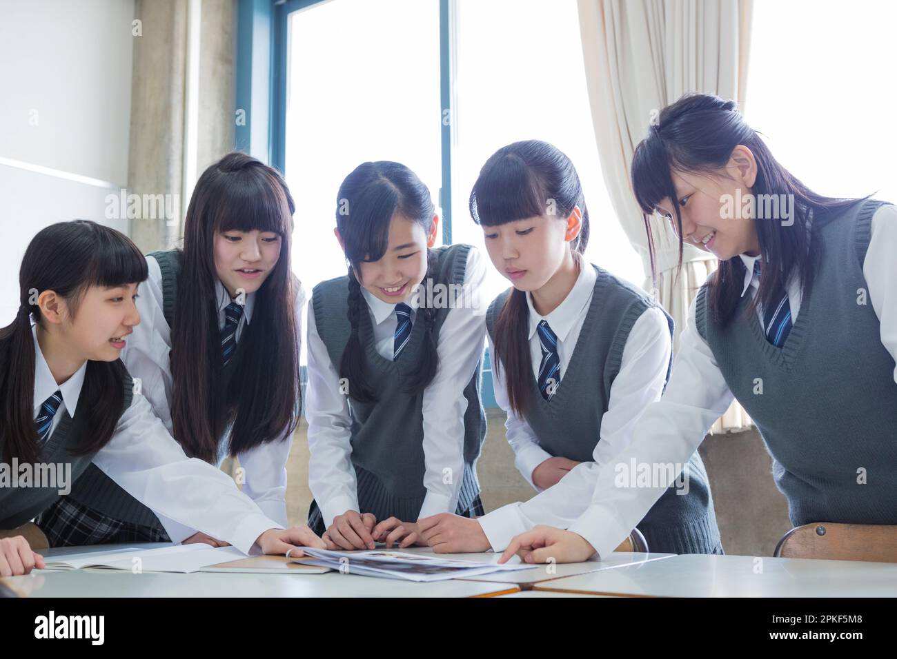 Junior high school girls doing group work Stock Photo - Alamy