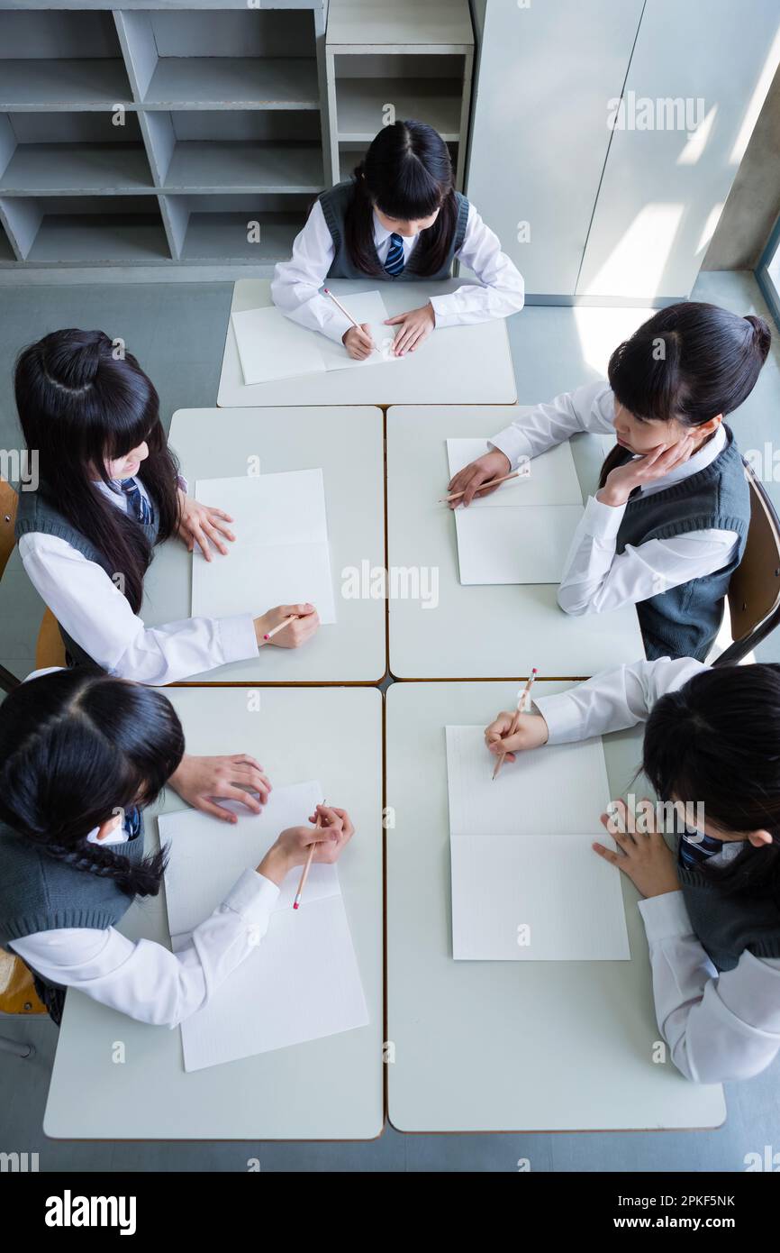 Junior high school girls doing group work Stock Photo - Alamy