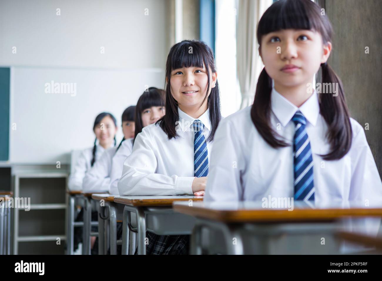Junior high school girls taking a class Stock Photo - Alamy