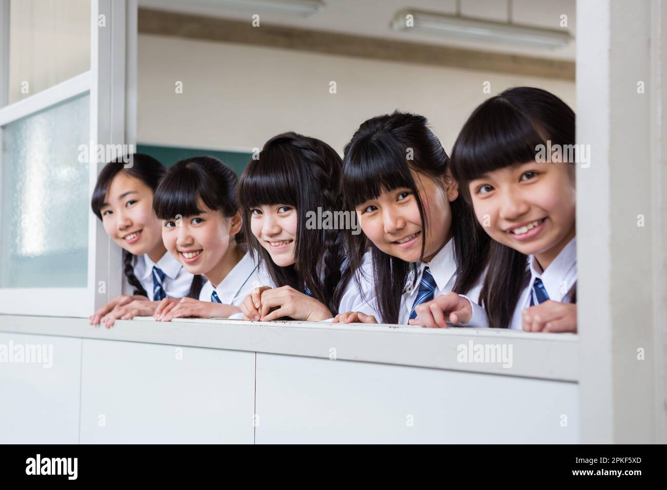 Junior High School Girls Looking Out of a Window Stock Photo - Alamy
