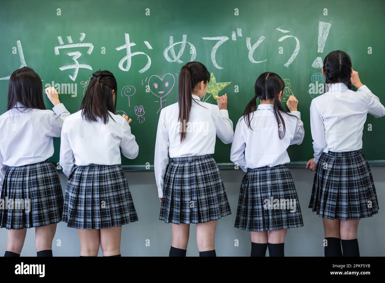 Junior High School Girls Writing with Chalk on the Blackboard Stock ...