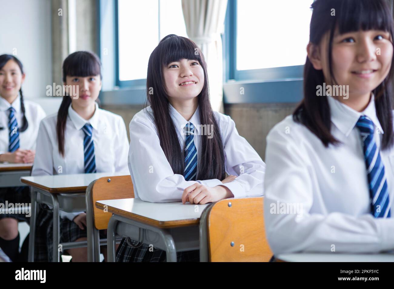 Junior high school girls taking a class Stock Photo - Alamy