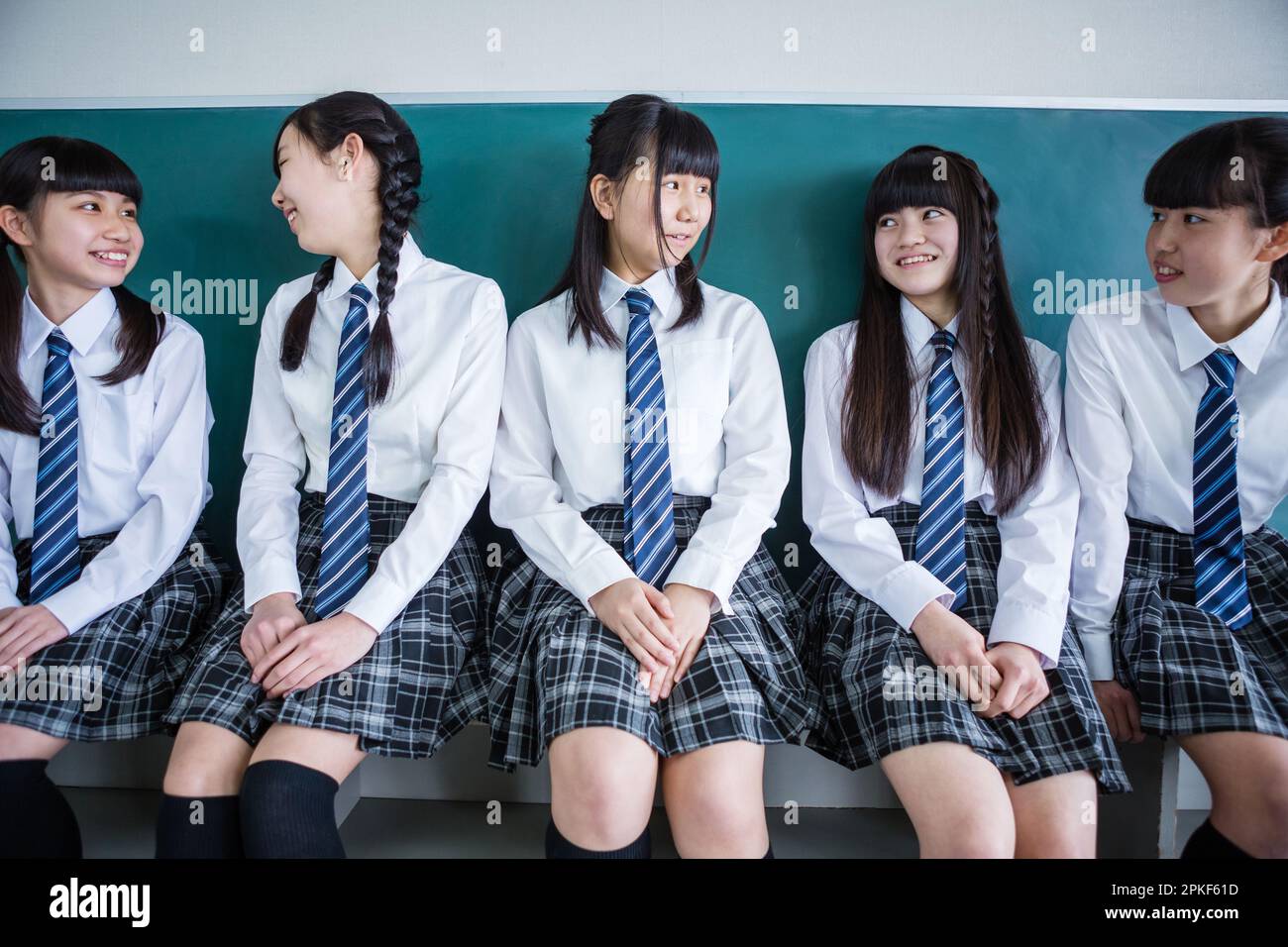 Junior high school girls getting along well with each other Stock Photo - Alamy