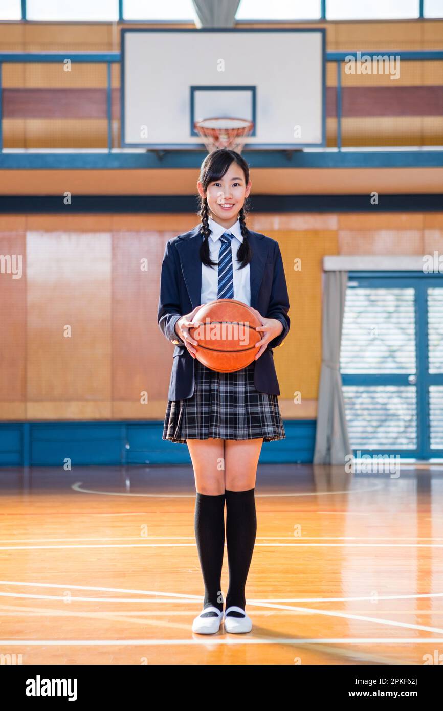 Junior high school girls holding a basketball Stock Photo - Alamy