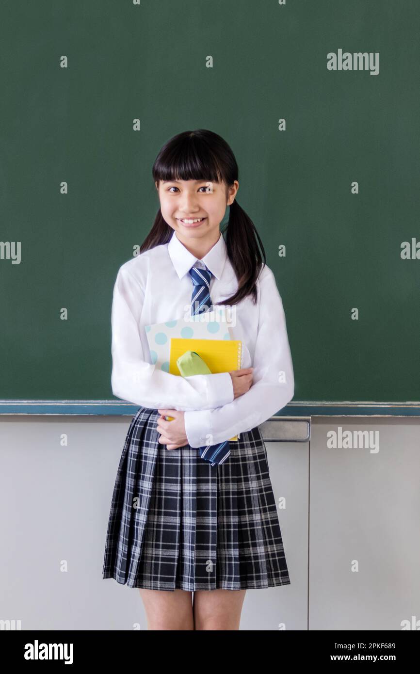 A junior high school girl standing in a classroom Stock Photo - Alamy