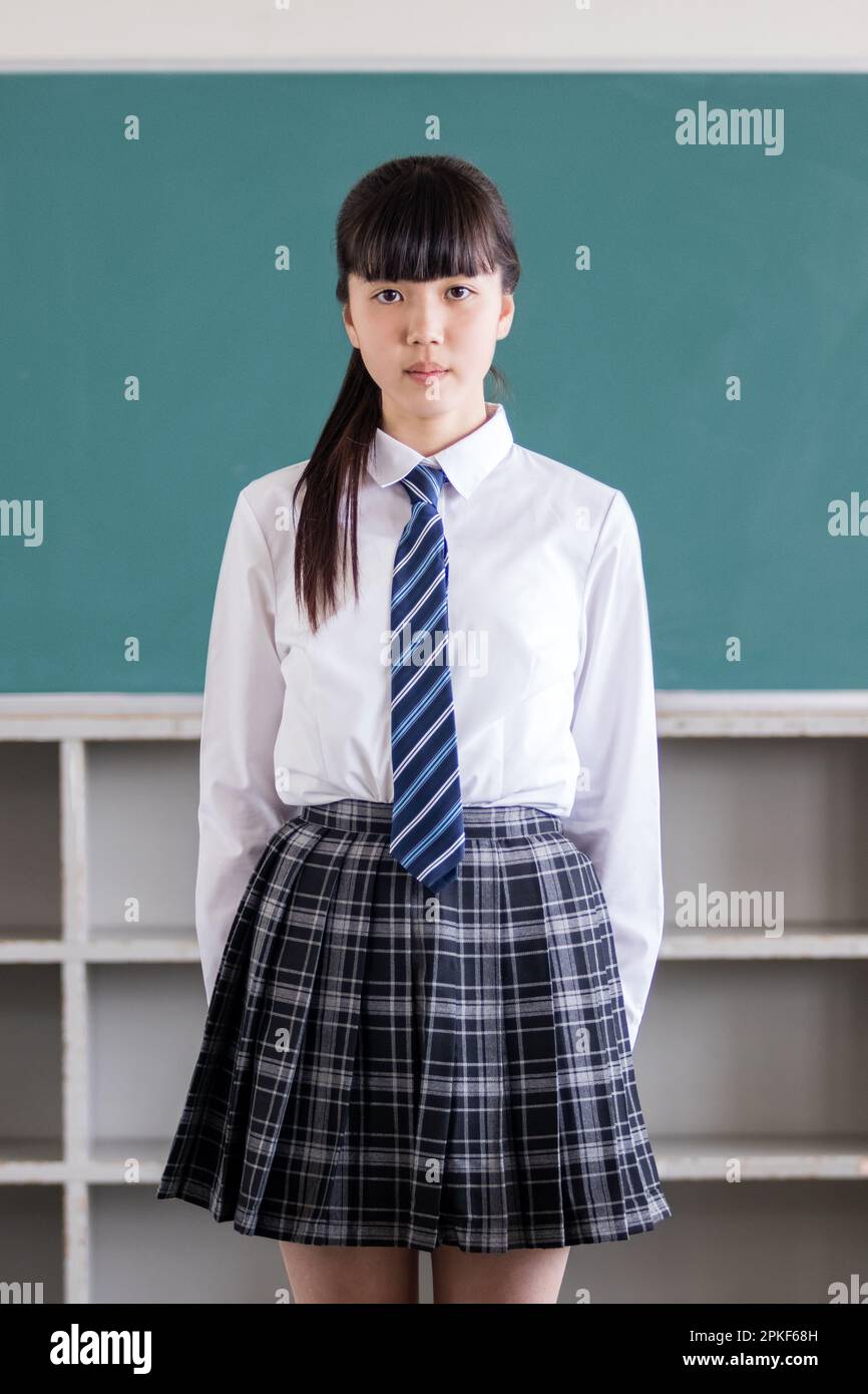 Junior high school girls standing in a classroom Stock Photo - Alamy