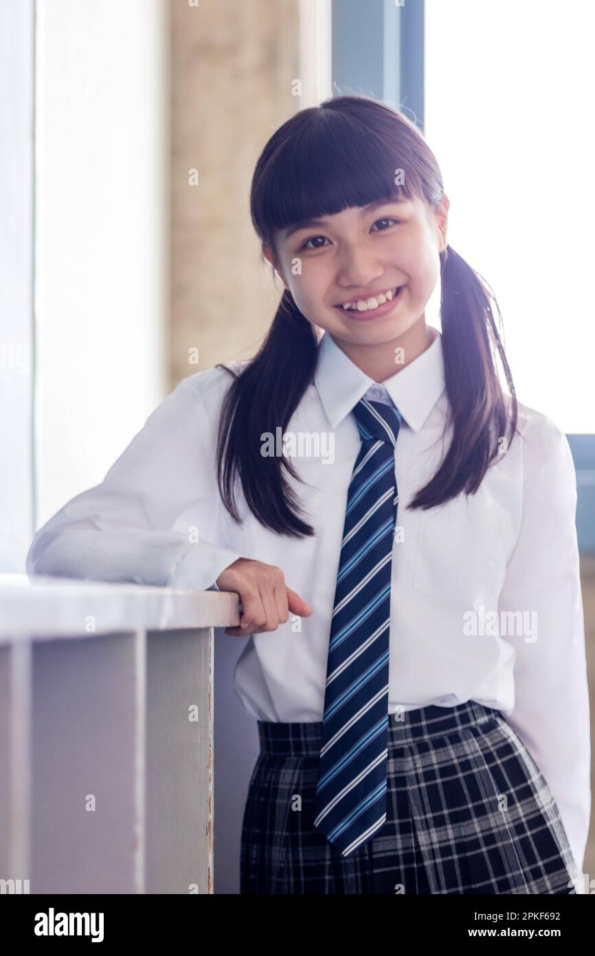 A junior high school girl standing in a classroom Stock Photo - Alamy