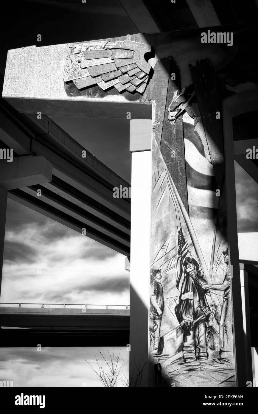 Shadow with light shining upon a 9/11 mural under the spaghetti bowl at ...