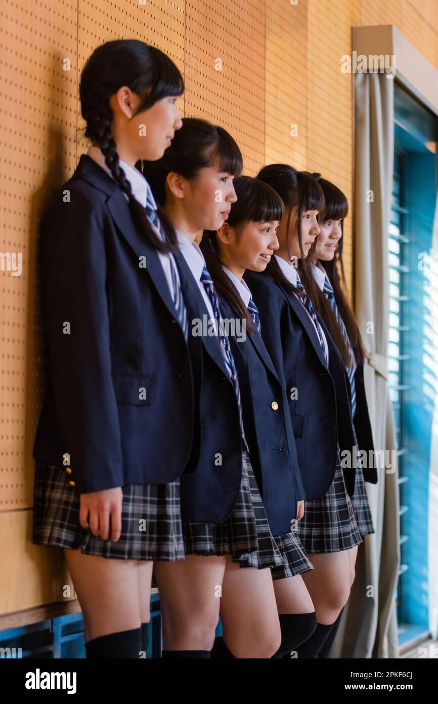 Junior high school girls standing in a row in the gym Stock Photo - Alamy