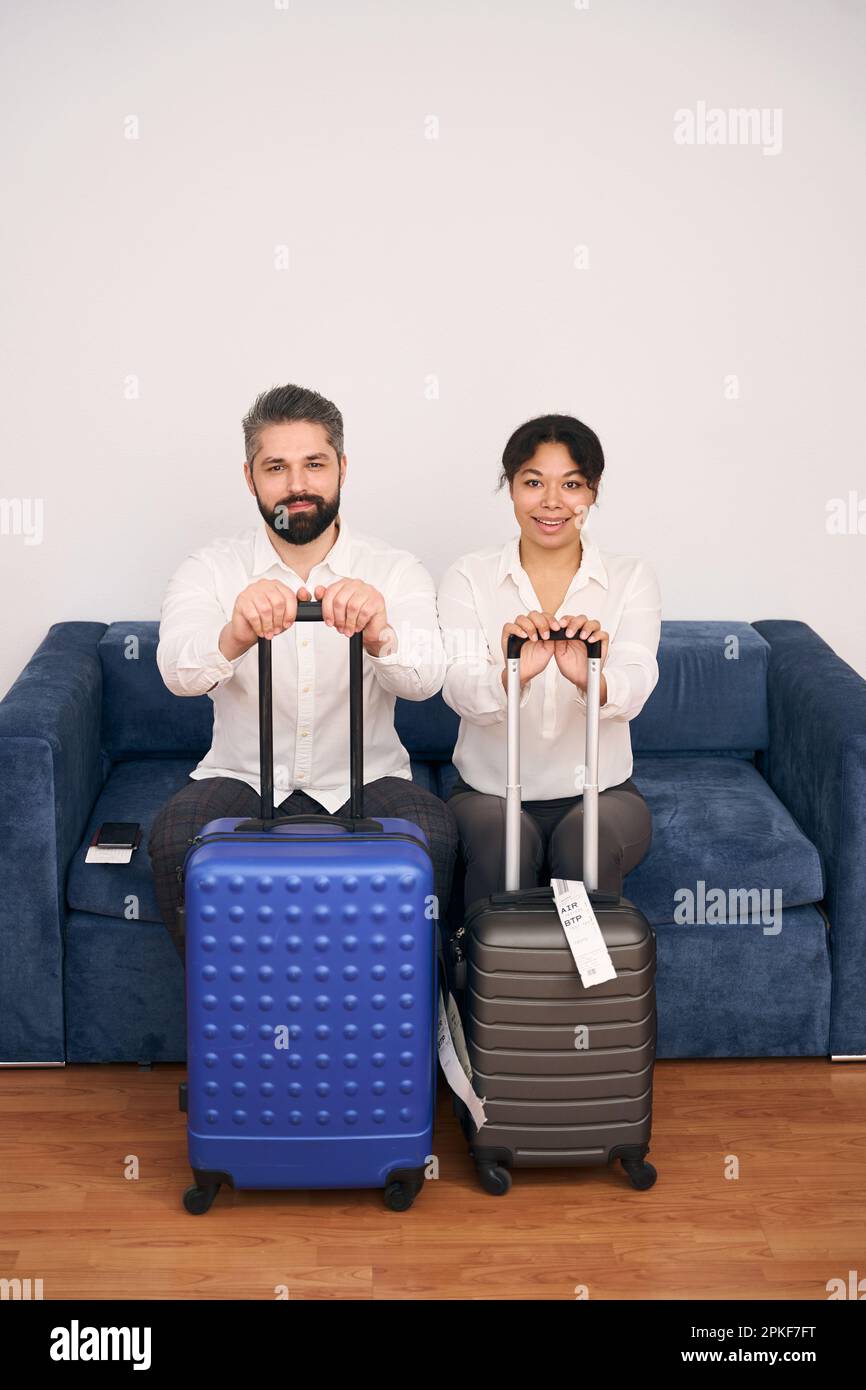 Young couple of tourists in hotel room Stock Photo - Alamy