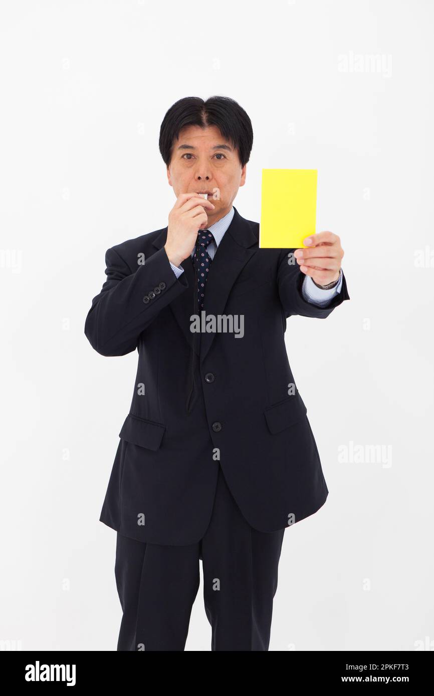 Man giving yellow card Stock Photo - Alamy