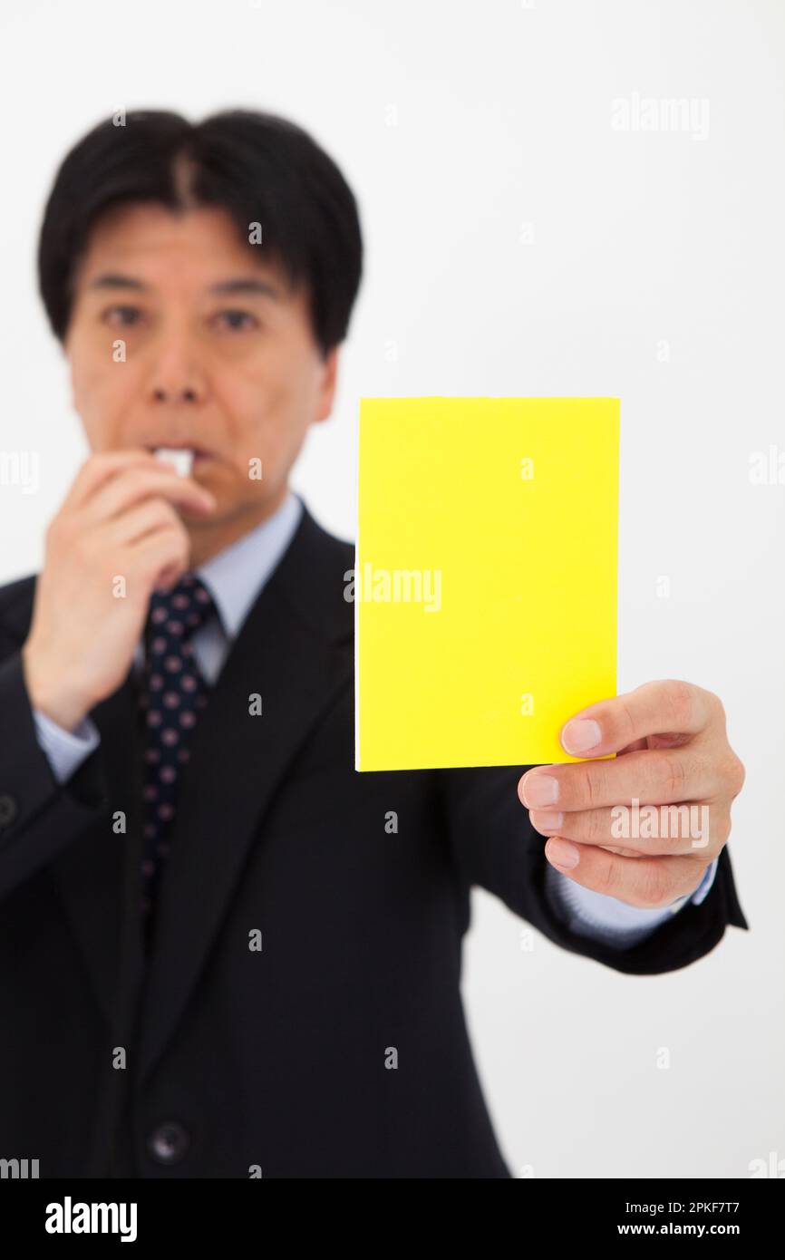 Man with yellow card Stock Photo - Alamy