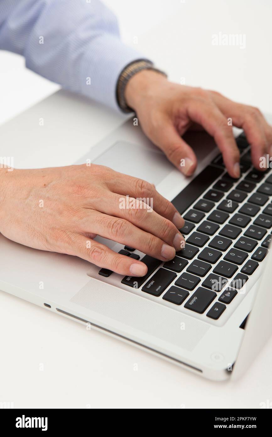 Hand operating a laptop Stock Photo - Alamy