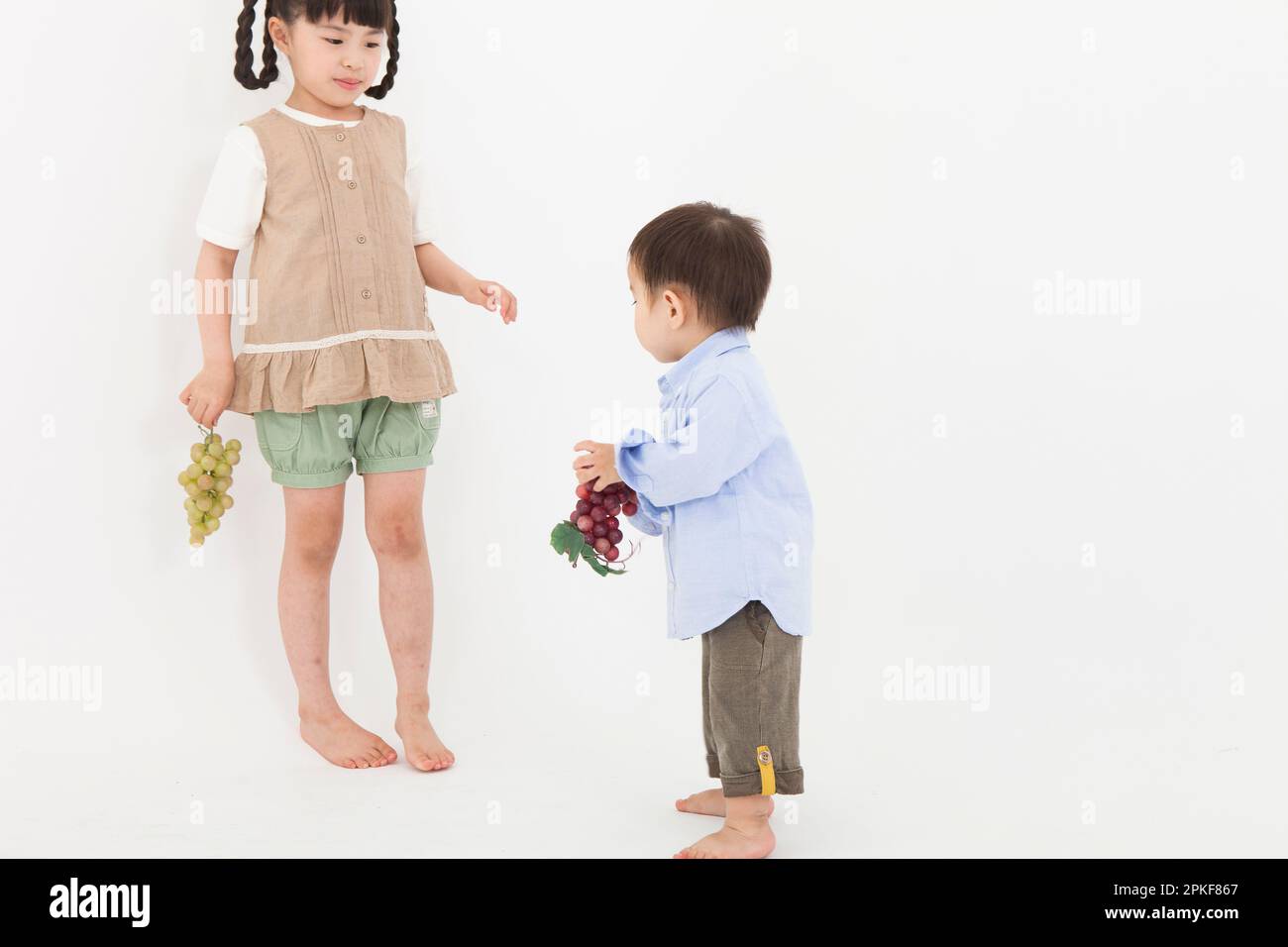 Boy and girl playing well Stock Photo - Alamy