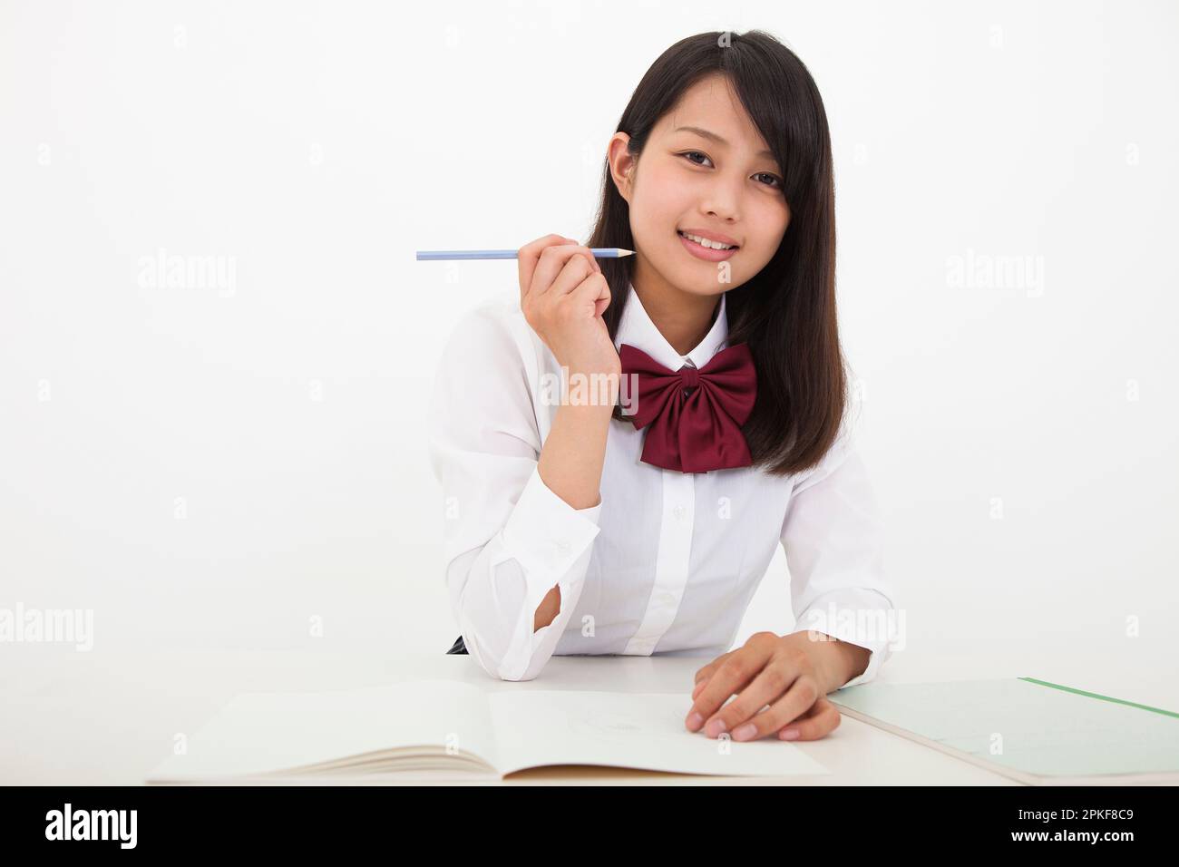 High school student holding a pencil Stock Photo - Alamy