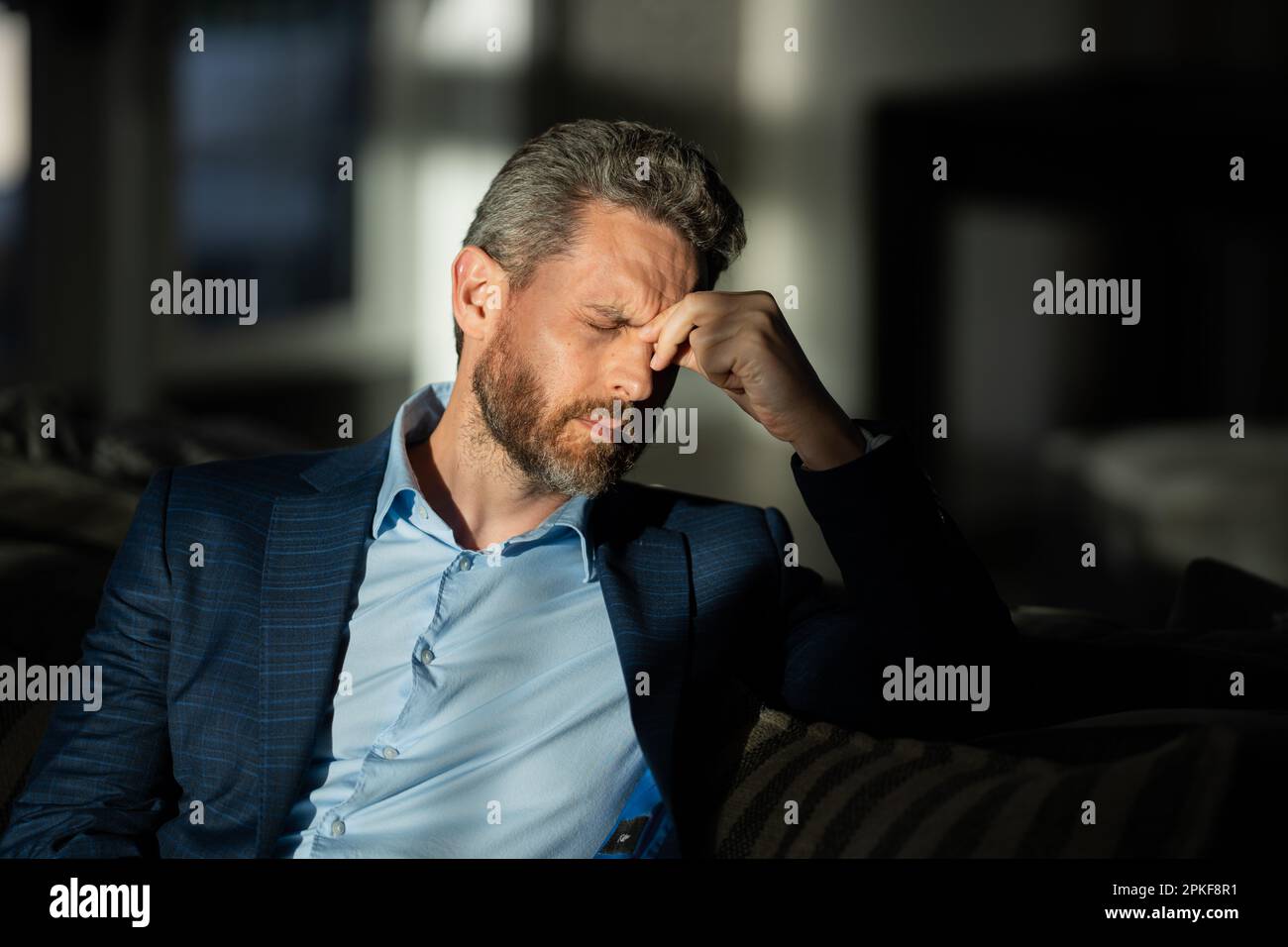 Man with sinus headache, tension or cluster headache, close up portrait ...