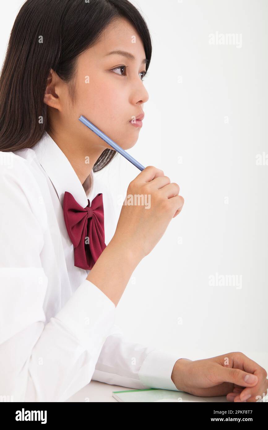 High school student holding a pencil Stock Photo - Alamy