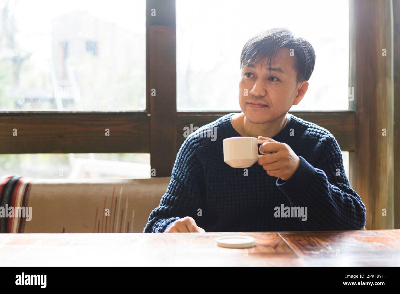 Man drinking coffee at a cafe Stock Photo - Alamy