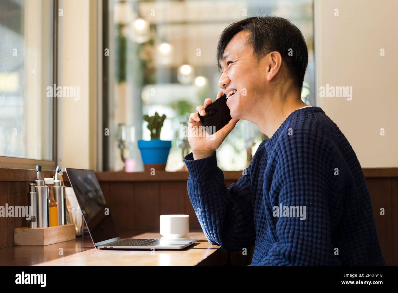 Man making a phone call in a café Stock Photo - Alamy