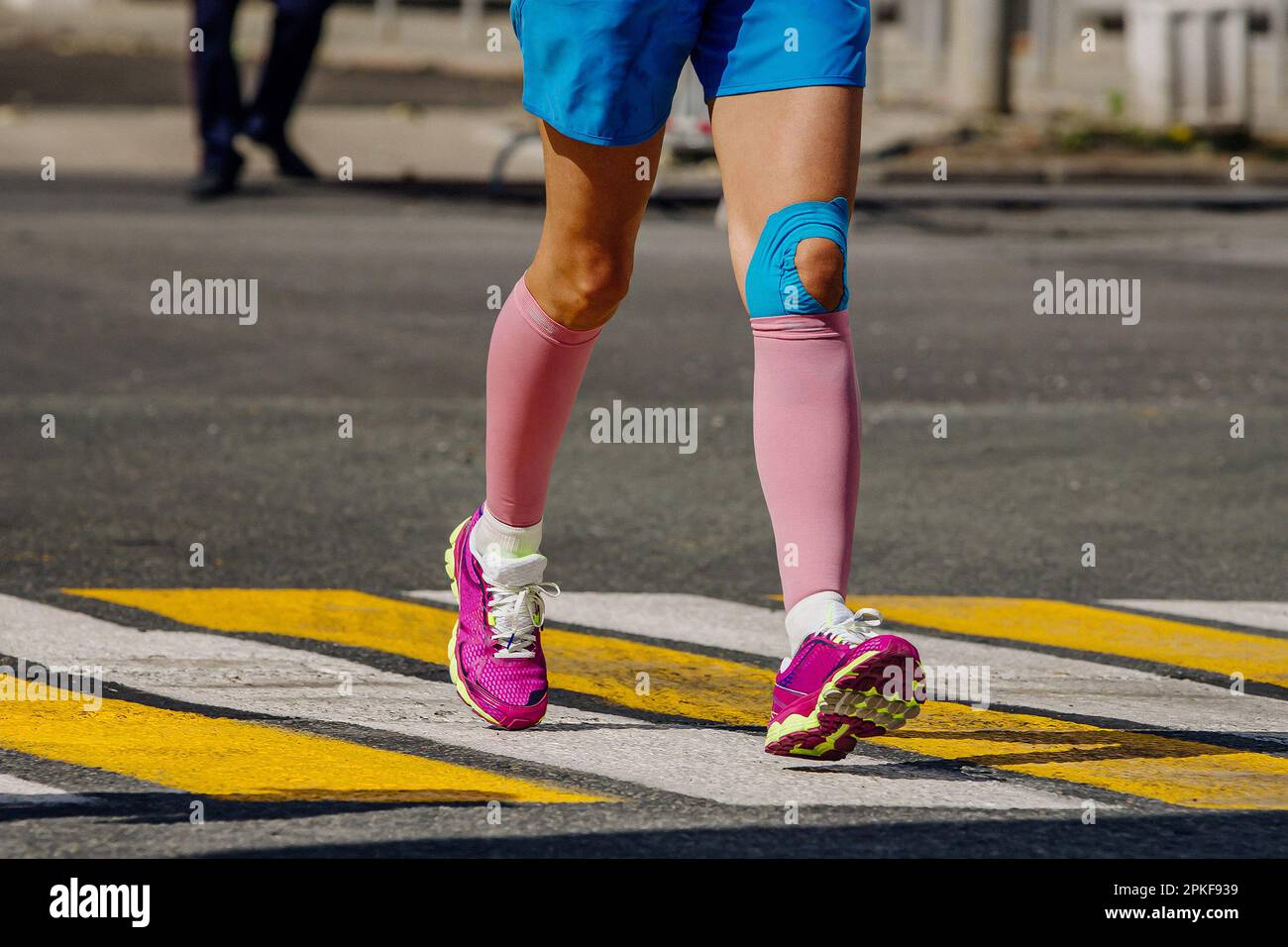 legs female runner in pink compression socks running pedestrian ...
