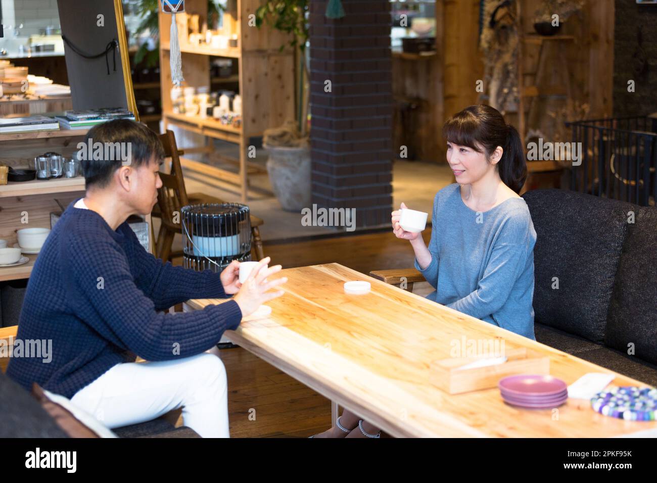 Asian couple talking drinking coffee hi-res stock photography and ...