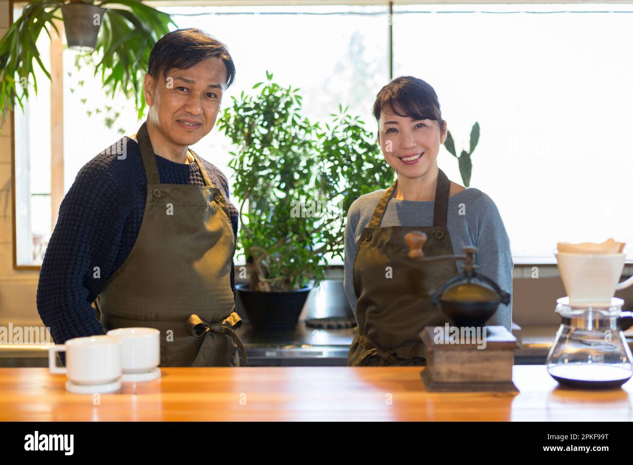 A couple standing at the counter of a café Stock Photo - Alamy