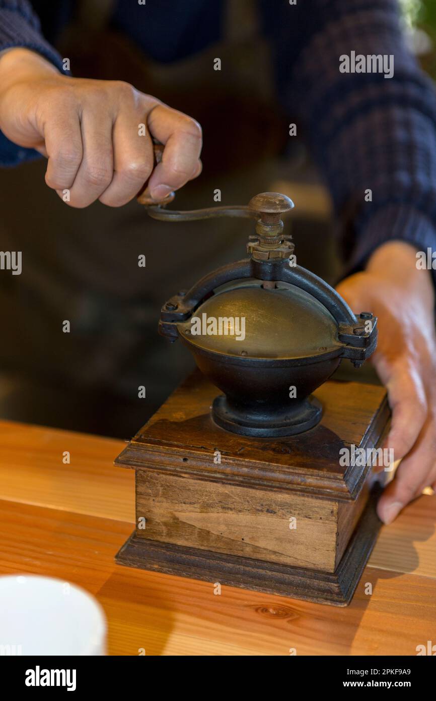 Male hand coffee grinder hi-res stock photography and images - Alamy