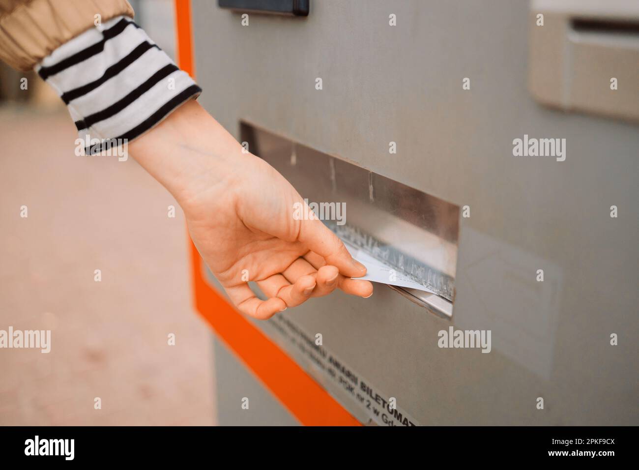 Woman buying a ticket to the subway train using an electronic terminal ...