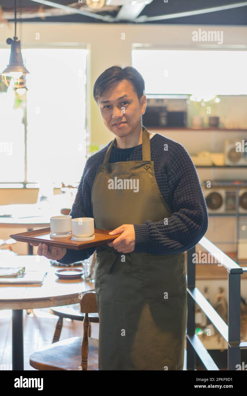 Male clerk standing with a tray Stock Photo - Alamy