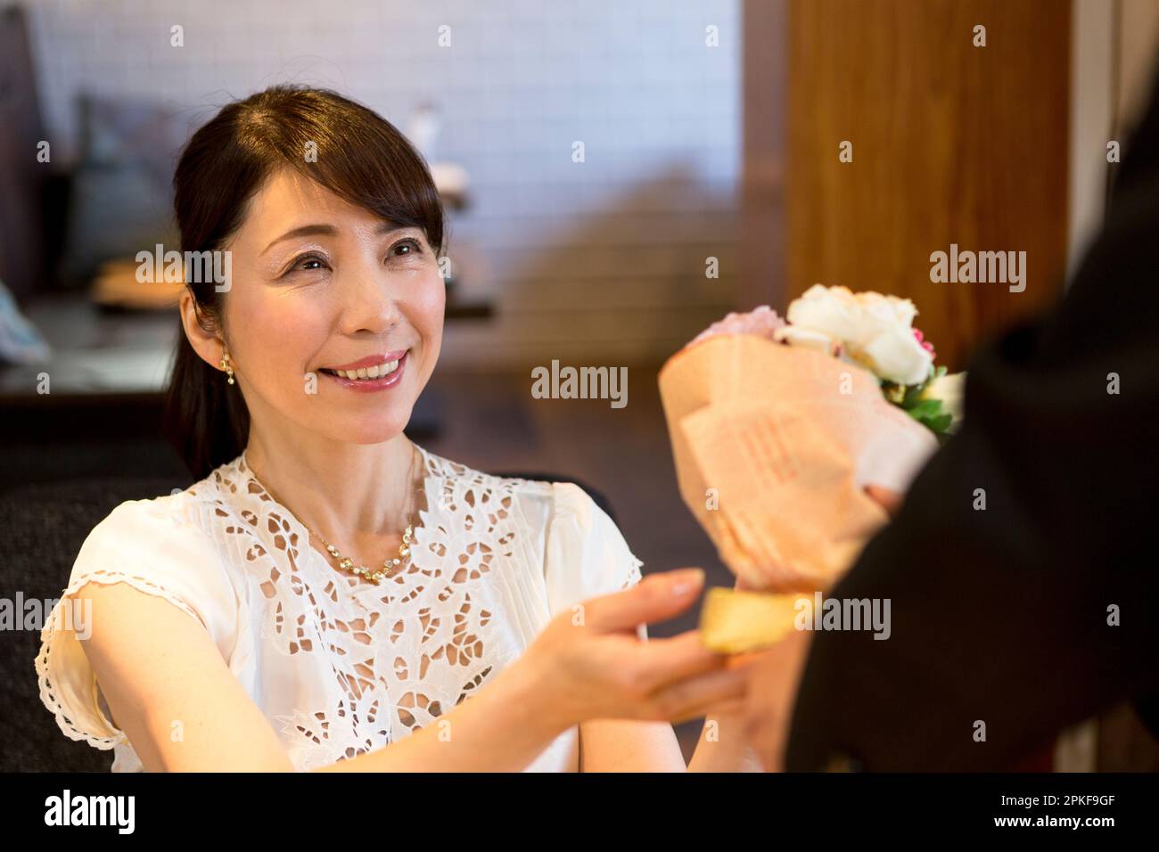 Woman receiving a bouquet of flowers Stock Photo - Alamy