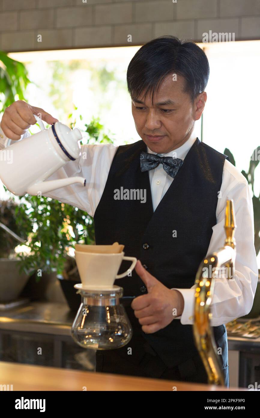 A male waiter making coffee Stock Photo - Alamy