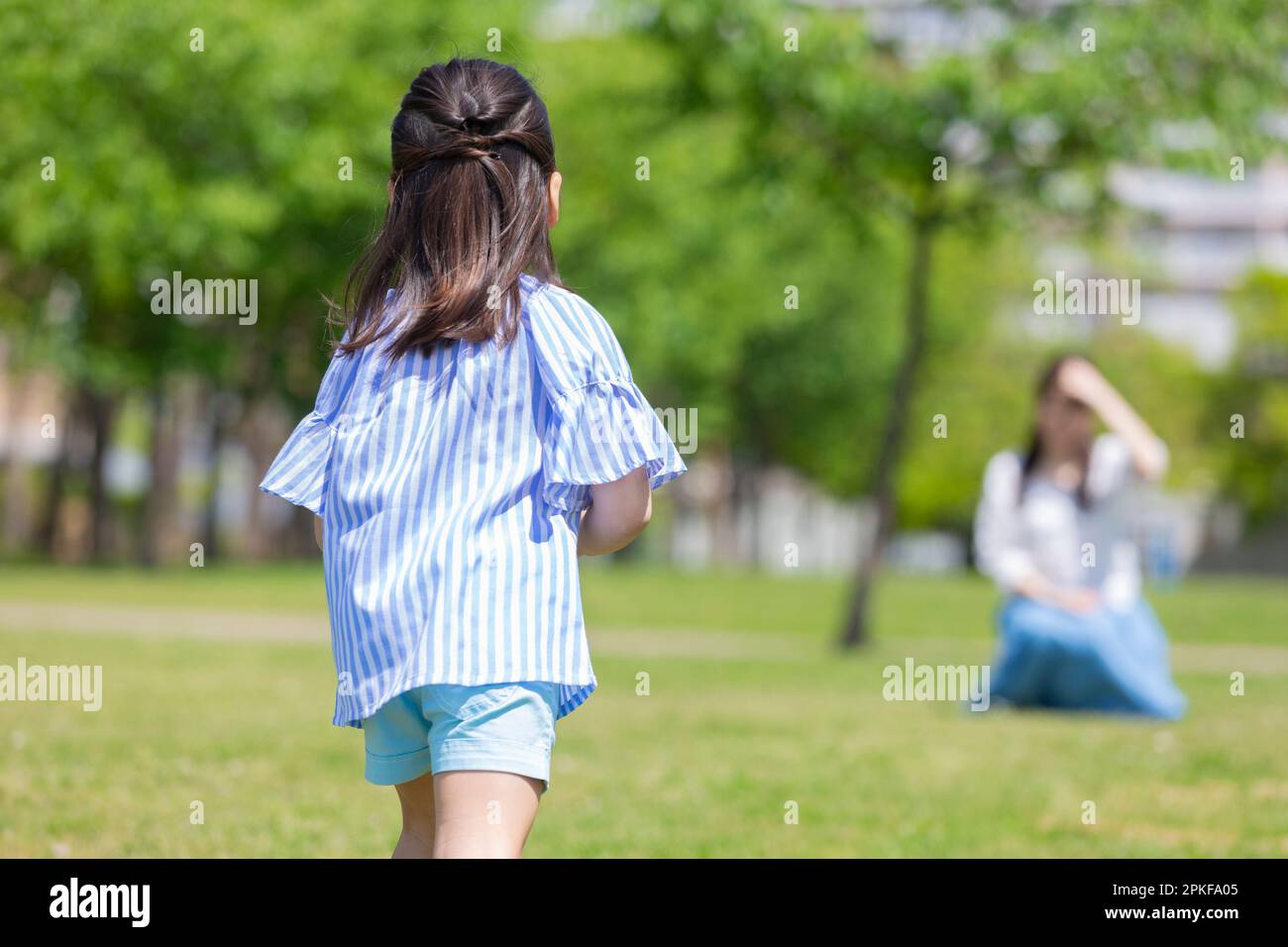 Running Daughter and Hugging Mother Stock Photo - Alamy
