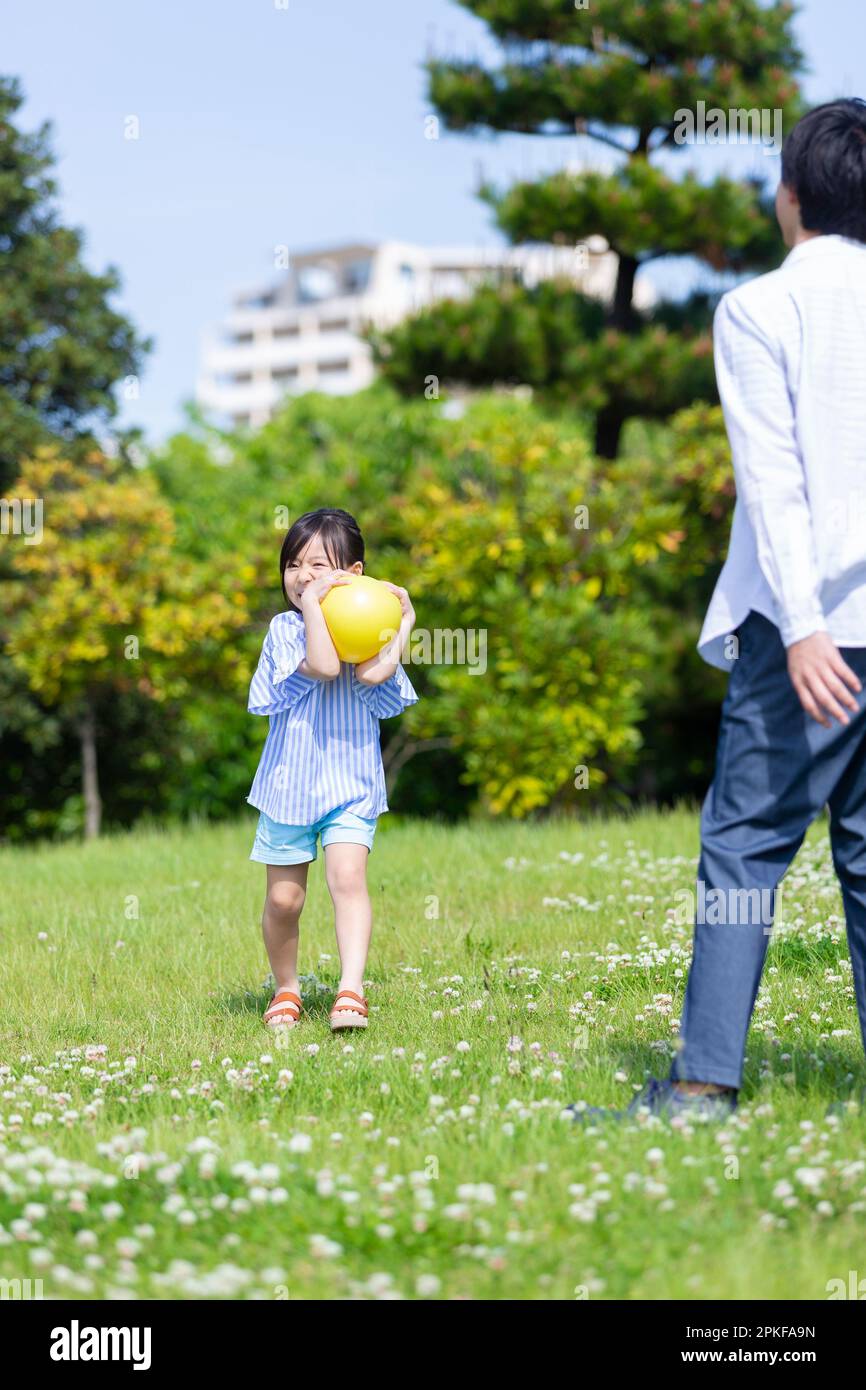 Parent and child playing with a ball Stock Photo - Alamy