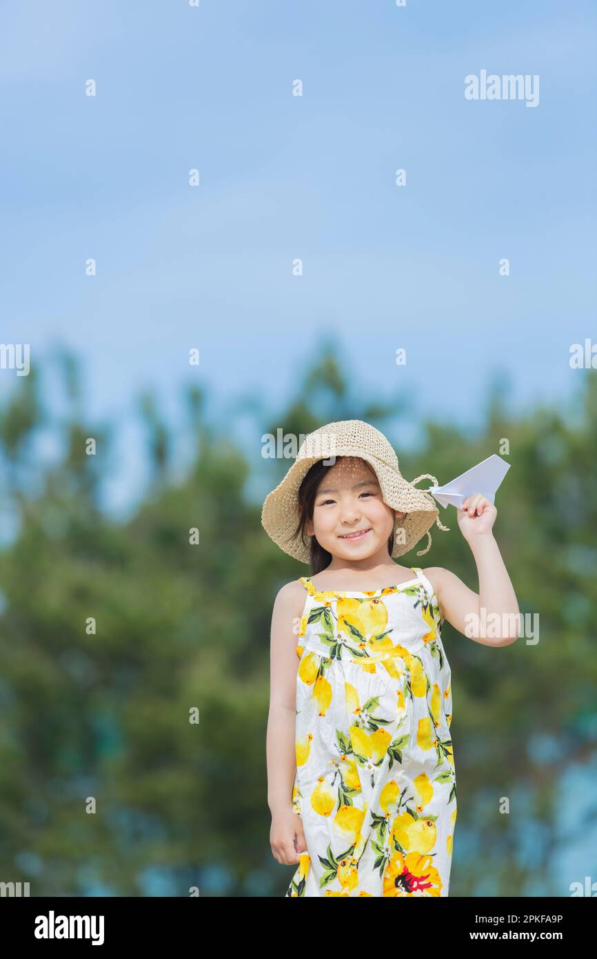 Girl Flying Paper Airplane Stock Photo - Alamy