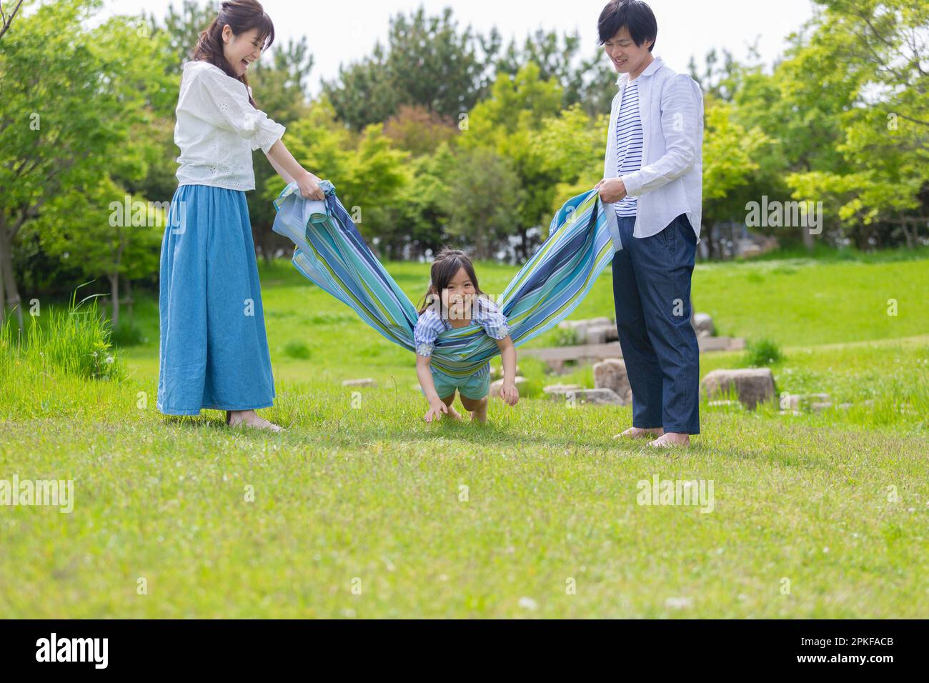 Family spreading out sheet Stock Photo - Alamy