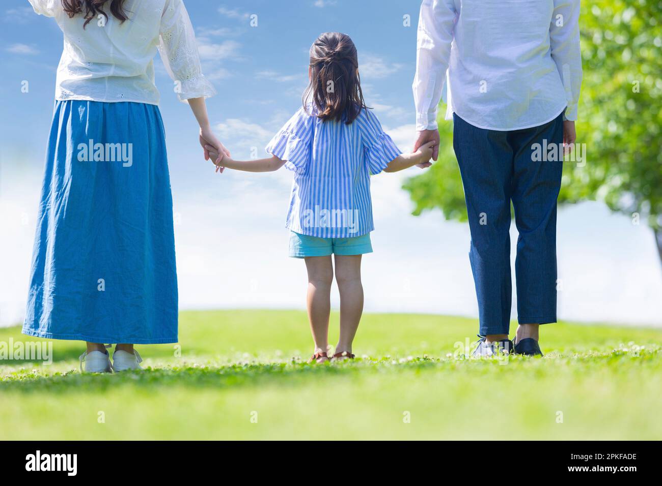 Family walking hand in hand Stock Photo - Alamy