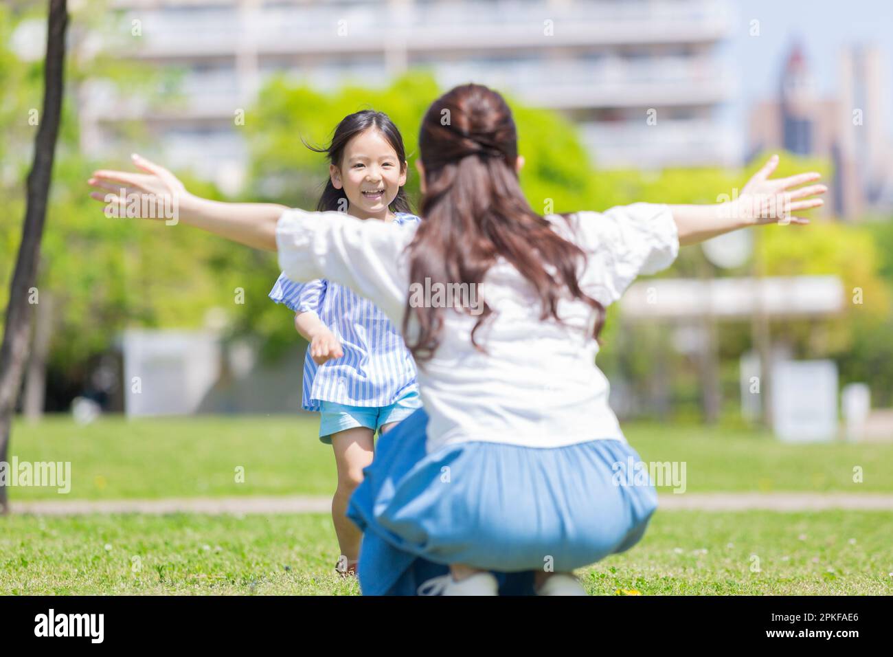 Running Daughter and Hugging Mother Stock Photo - Alamy