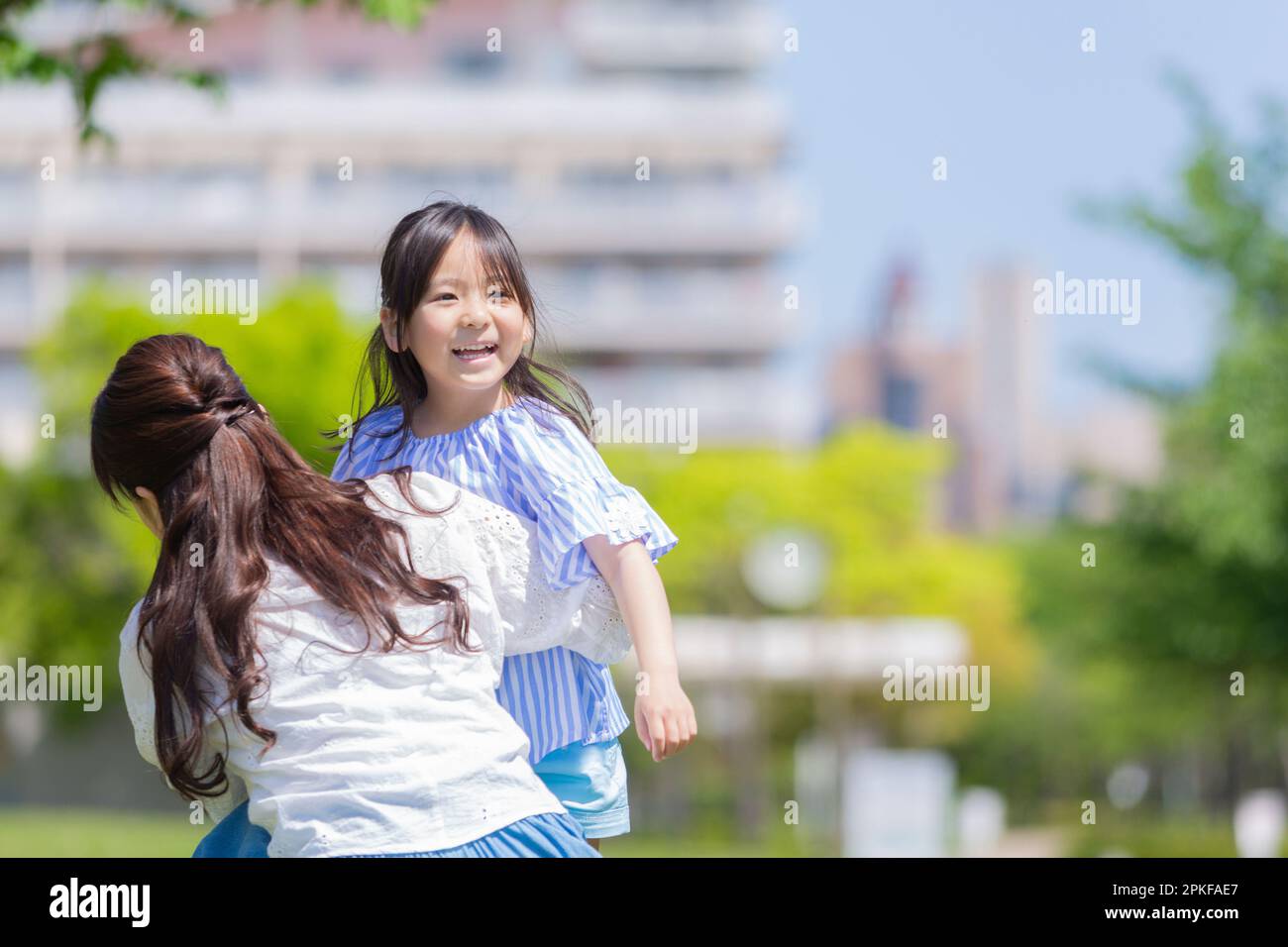 Running Daughter and Hugging Mother Stock Photo - Alamy