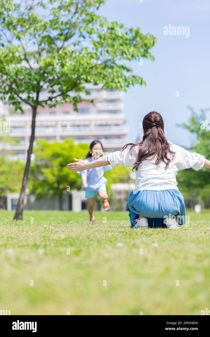 Mother holding her running daughter Stock Photo - Alamy