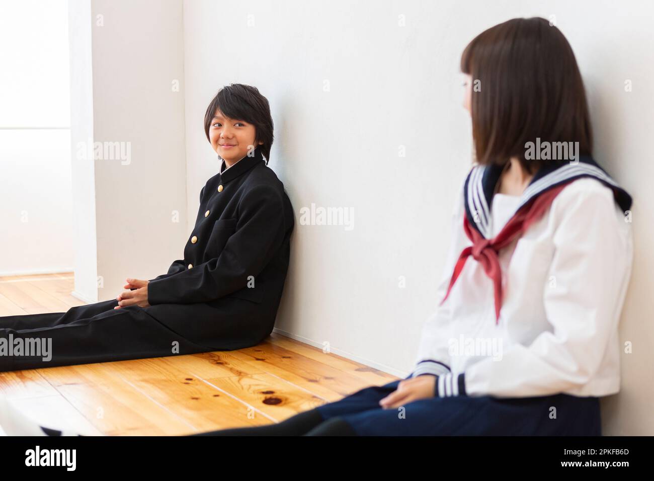 Junior high school student sitting on the floor Stock Photo - Alamy