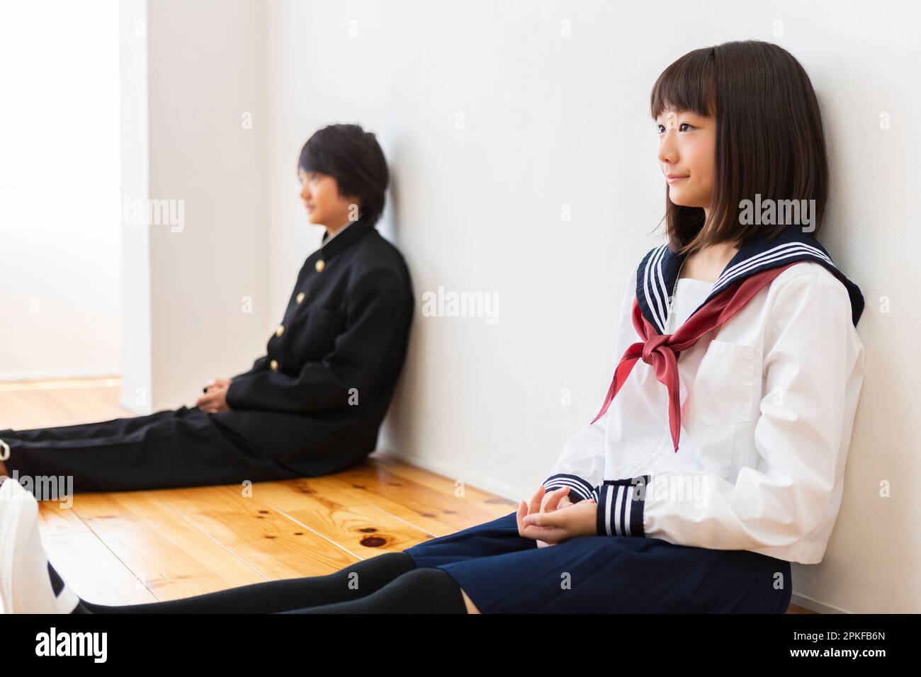 Junior high school student sitting on the floor Stock Photo - Alamy