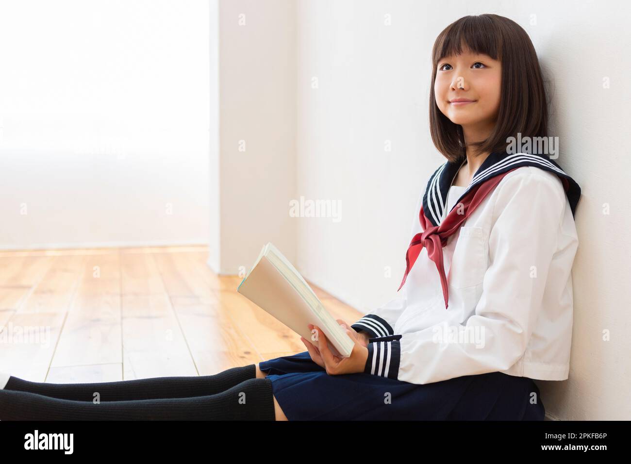 Junior High School Girl Reading on the Floor Stock Photo - Alamy