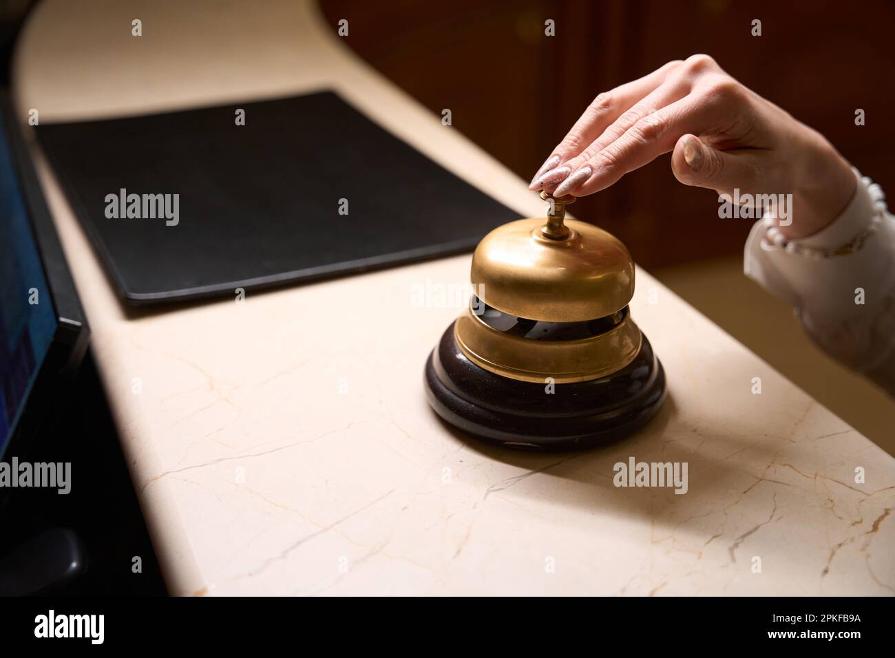 Woman presses the bell button to call the porter Stock Photo - Alamy